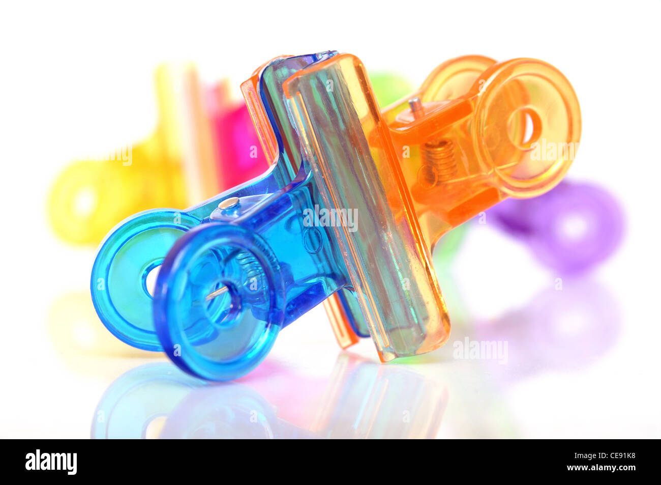 Multicolored office paper clips on white background Stock Photo - Alamy