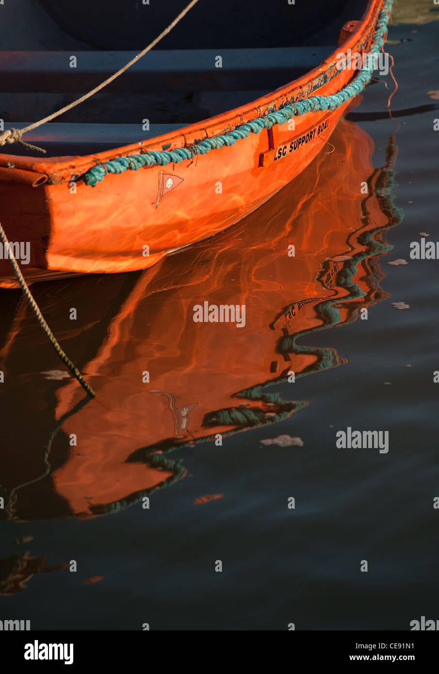 A brightly coloured dinghy floating on water Stock Photo - Alamy