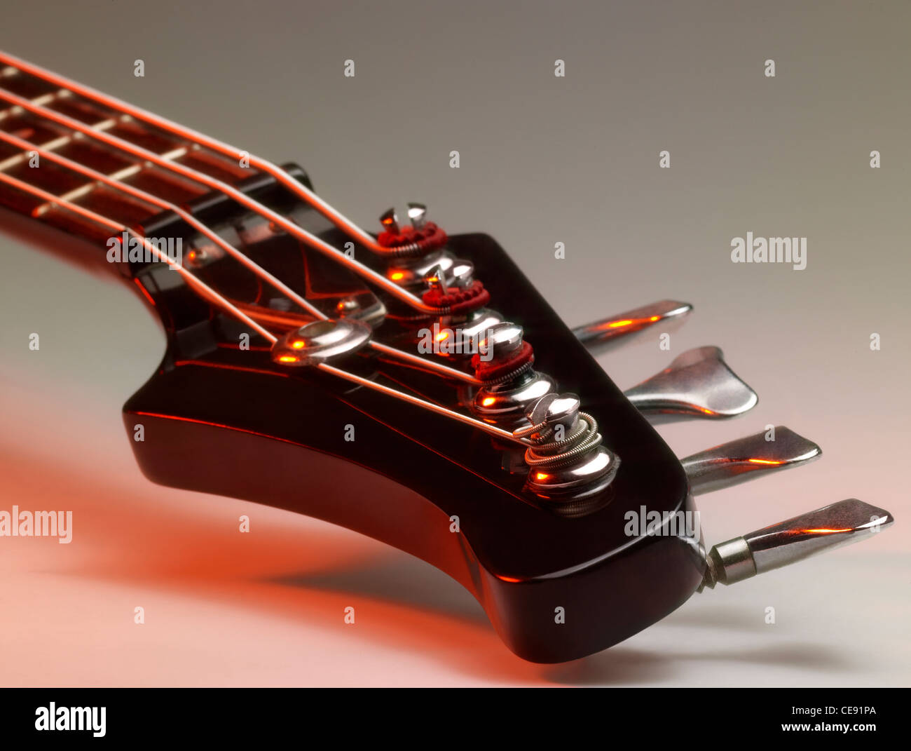 detail of a bass guitar with red light in grey back Stock Photo - Alamy