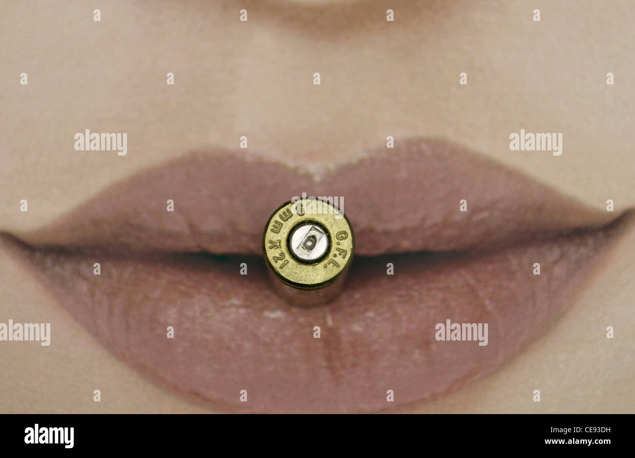 a bullet on the mouth of a woman poster Stock Photo - Alamy