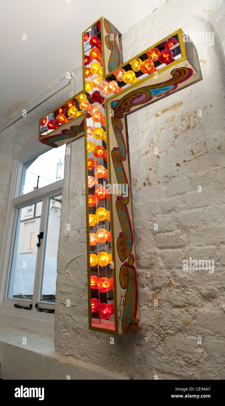 A Fairground crucifix with lights hangs from a wall. Picture by Pete ...