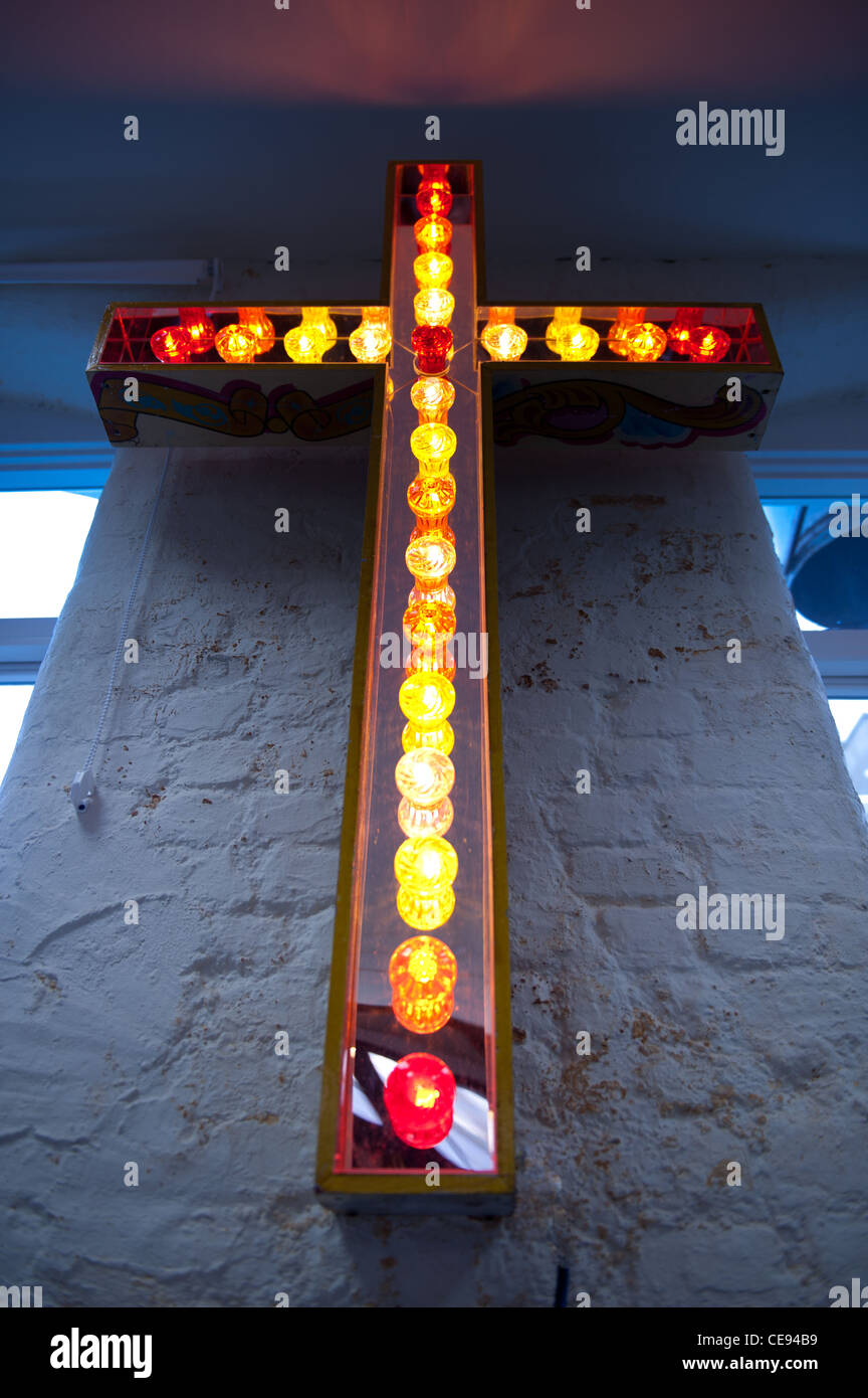 A Fairground crucifix with lights hangs from a wall. Picture by Pete ...