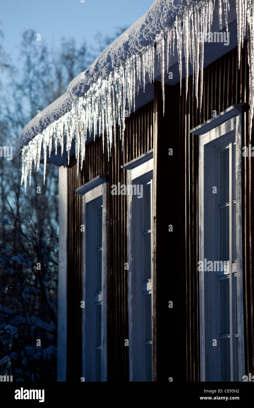 Icicles hanging from house eaves , Finland Stock Photo - Alamy