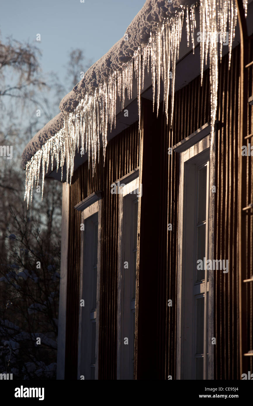 Icicles hanging from house eaves , Finland Stock Photo - Alamy
