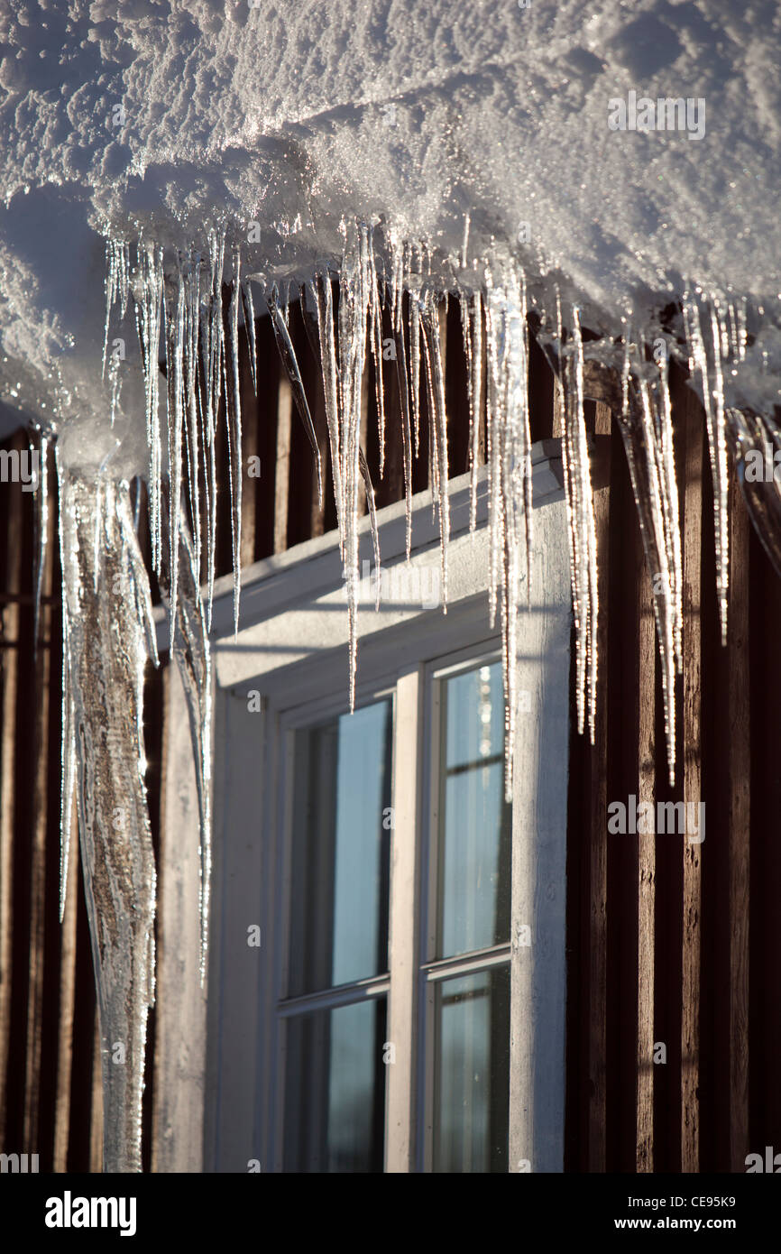 Icicles hanging from house eaves , Finland Stock Photo - Alamy