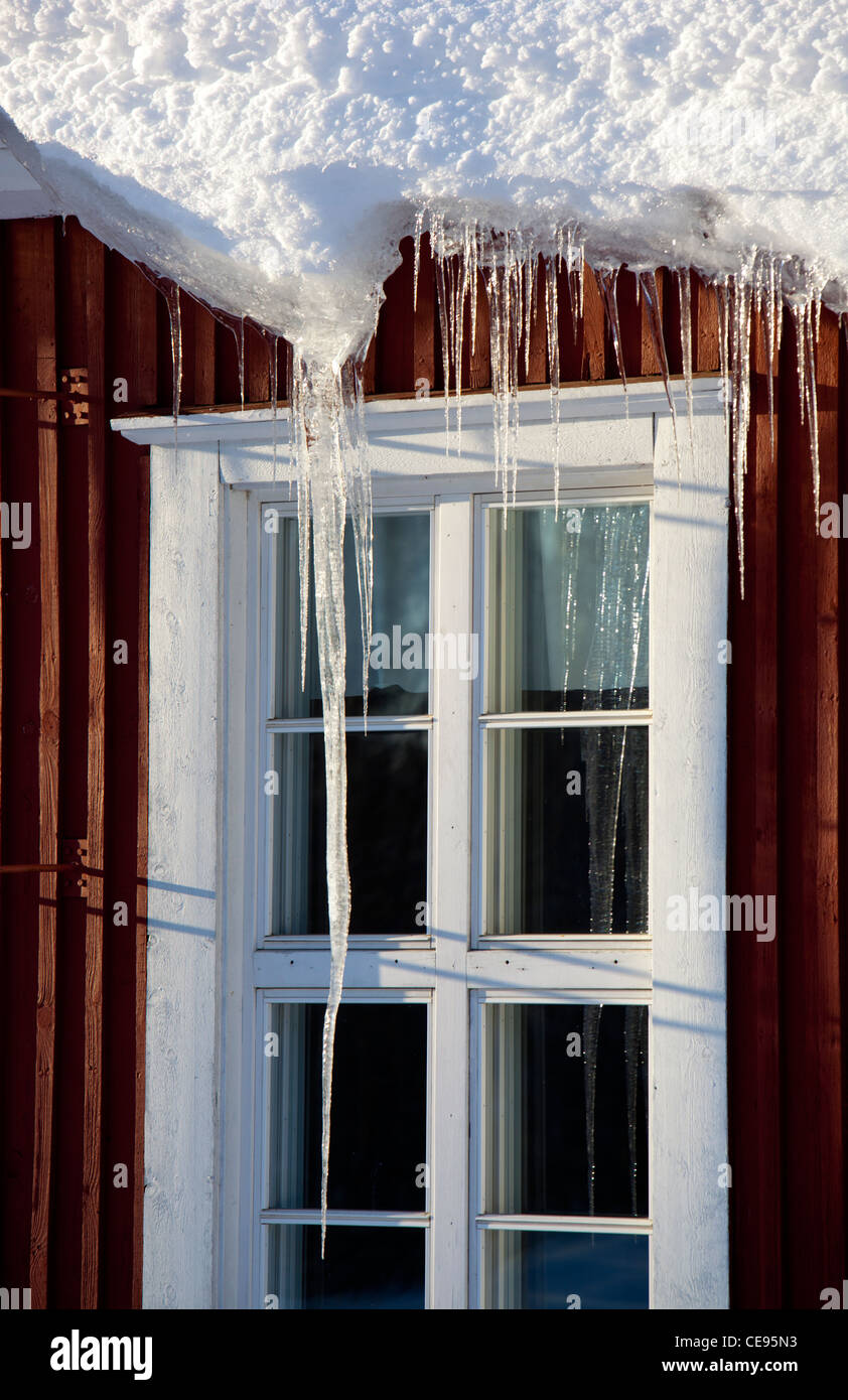 Icicles hanging from house eaves , Finland Stock Photo - Alamy