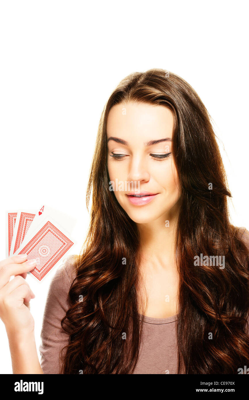 beautiful woman looking to the poker cards in her hand on white ...