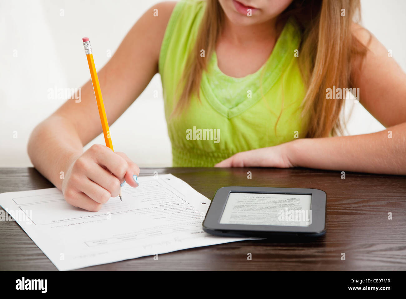 Girl doing homework using tablet pc Stock Photo - Alamy