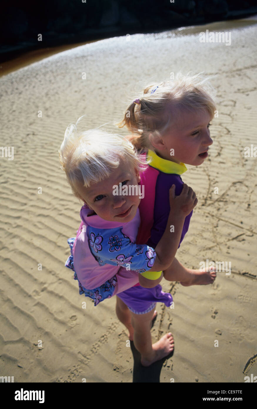 Young child age 8 with younger sister age 3 on piggy back Stock Photo ...