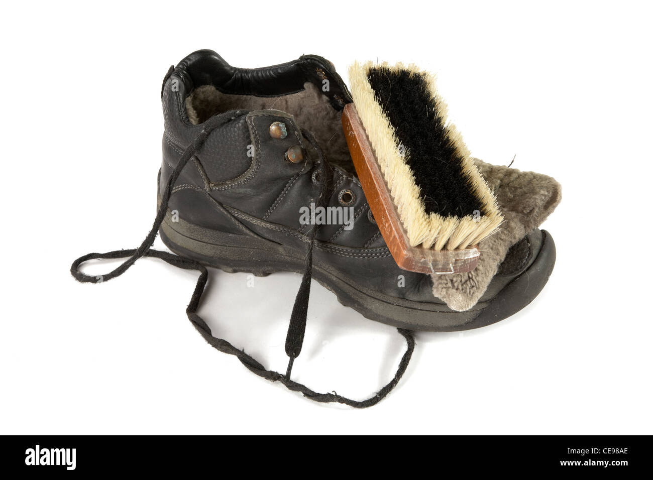 Old boot with shoe brush on a white background Stock Photo - Alamy
