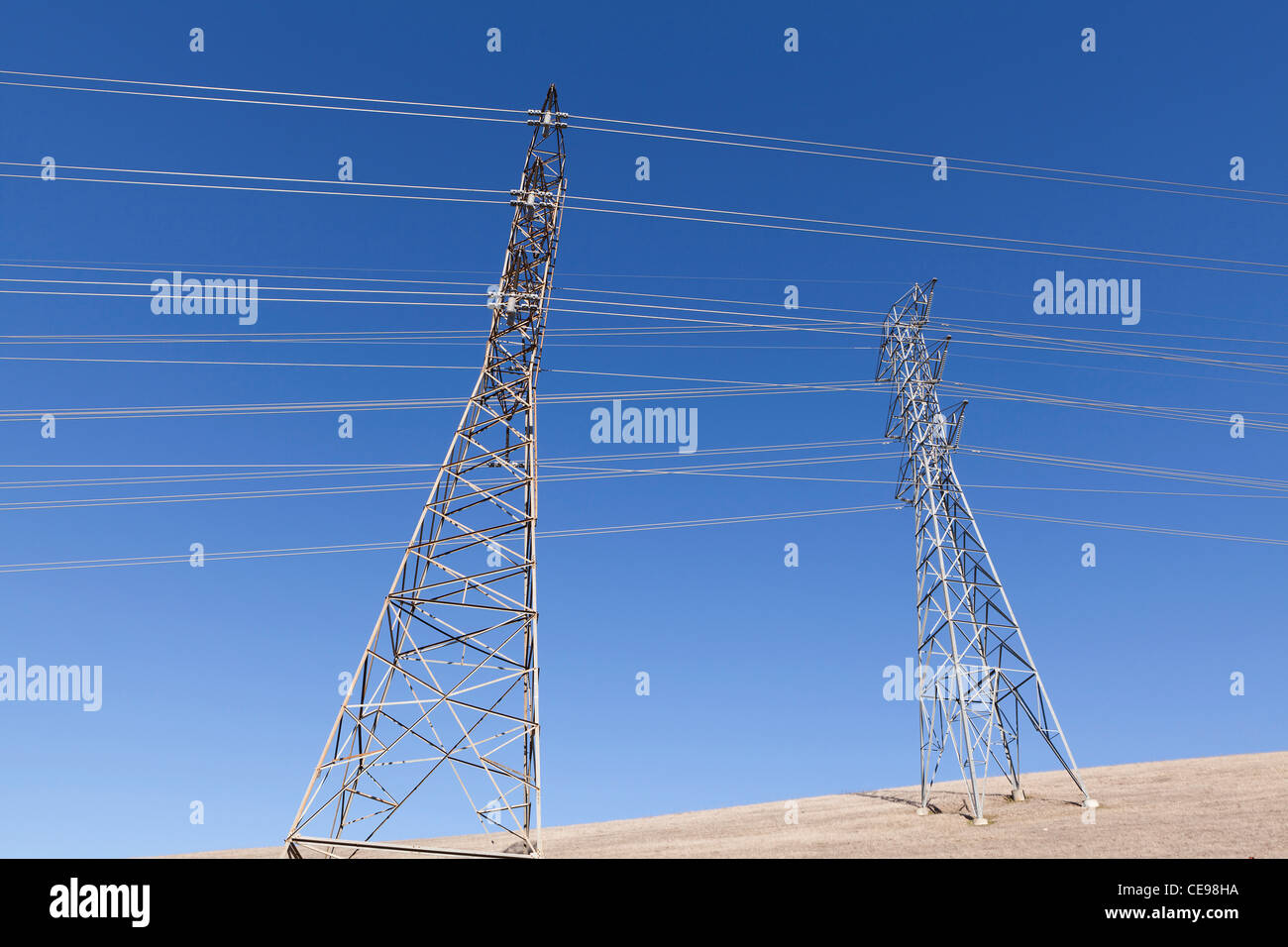 Electricity pylons against blue sky - California, USA Stock Photo - Alamy
