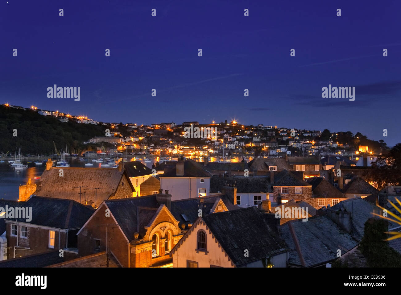 The rooftops at night over the town of Fowey, Cornwall, UK, looking ...