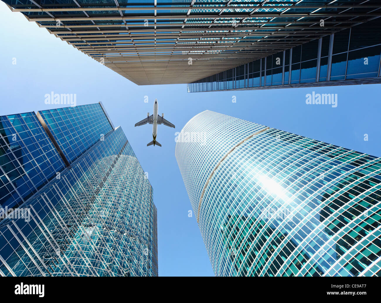 Airliner flying over high-rise buildings - skyscrapers Stock Photo - Alamy