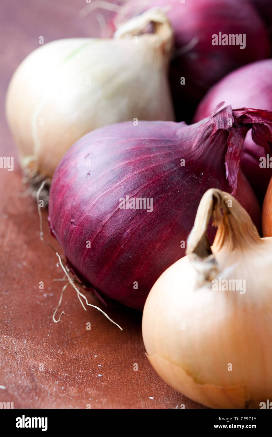Close-up of red and yellow onions on a wooden background Stock Photo ...