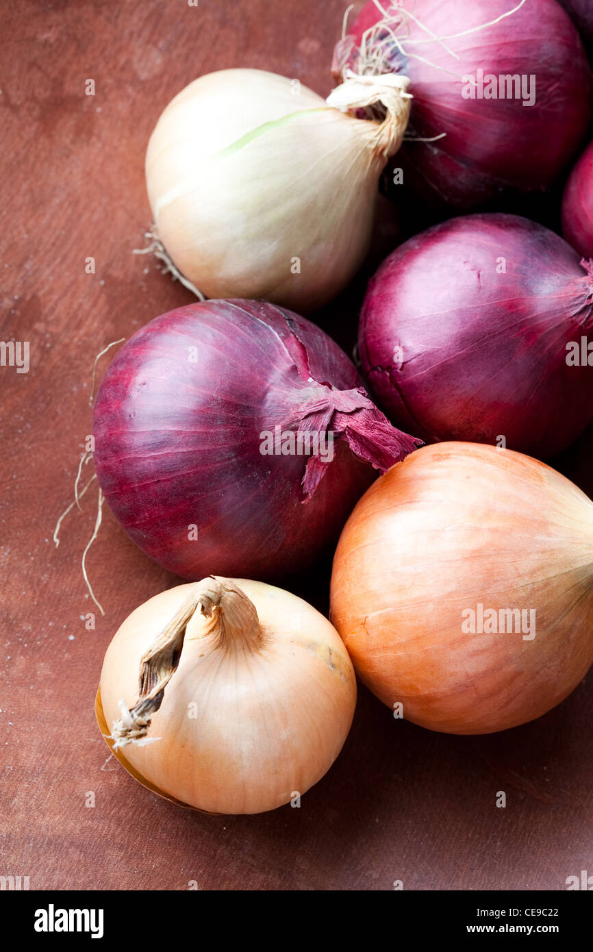 Close-up of red and yellow onions on a wooden background Stock Photo ...