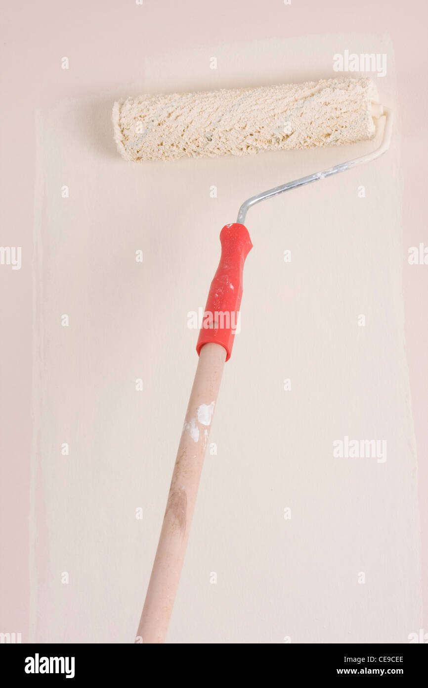 house painter using a paint roller, painting a wall in motion Stock ...