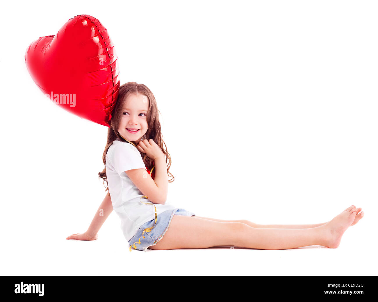 Cute Six Year Old Girl With A Big Red Heart Shaped Balloon Isolated