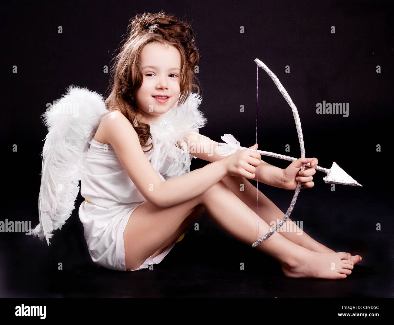 Cute Six Year Old Girl Dressed As A Cupid With White Wings Bow And