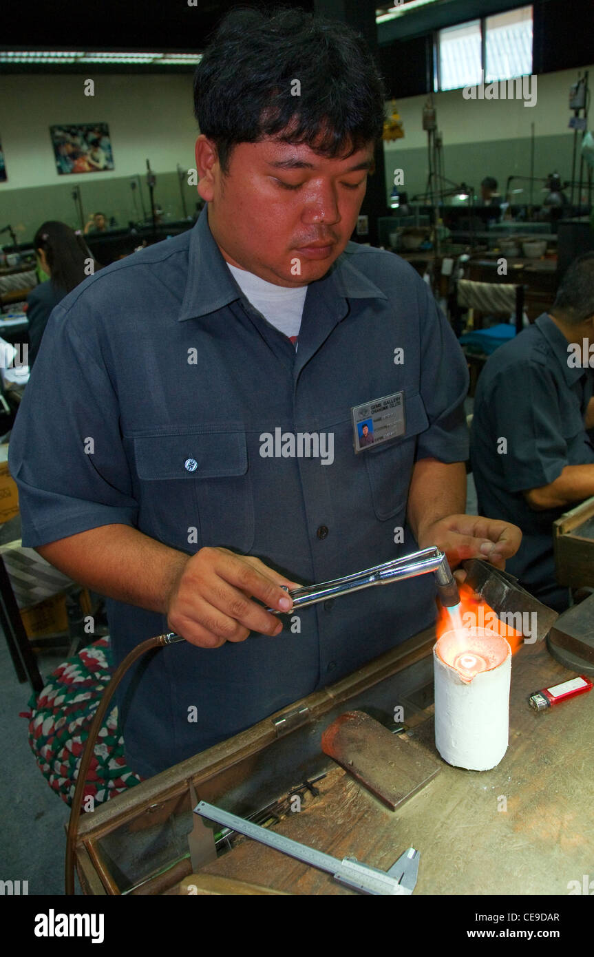 A gold Smith melting gold at a gems and jewellery production factory ...