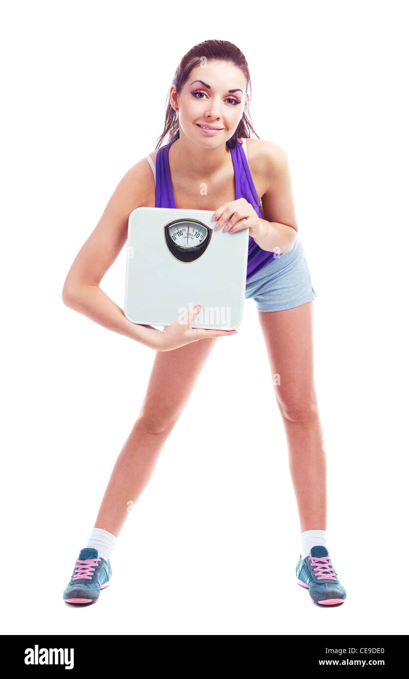 beautiful young woman wearing sports clothes holding scales Stock Photo ...