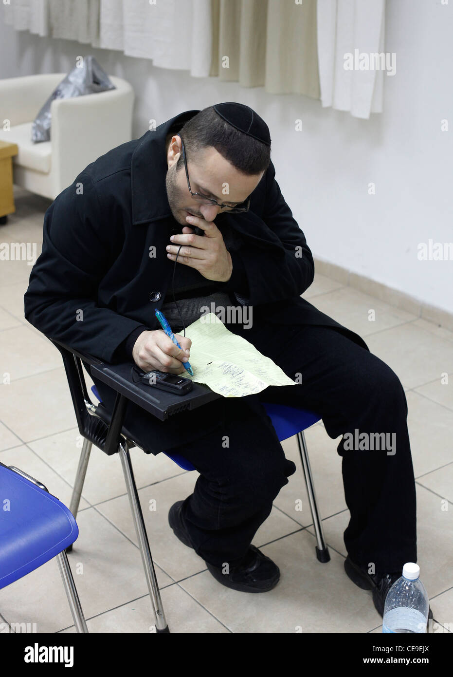Orthodox Jewish man attending a lecture in Israel Stock Photo - Alamy