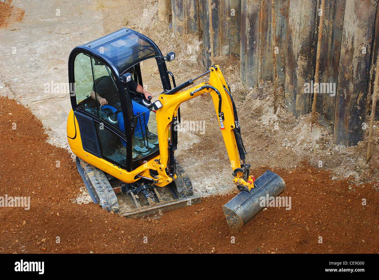 Small yellow excavator Stock Photo - Alamy
