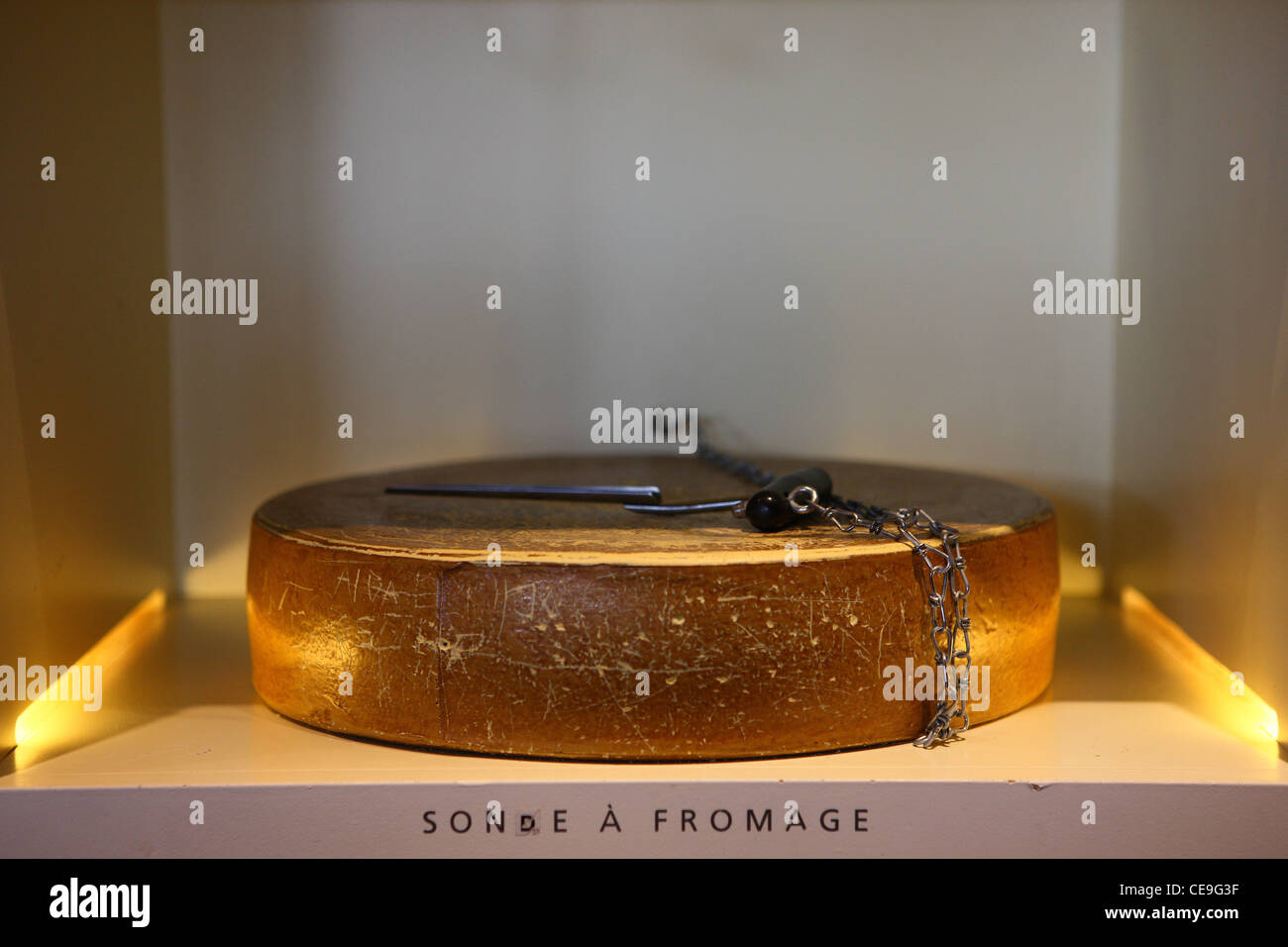 Cheese factory in Gruyères, Switzerland. Cheese ripening on the shelves ...