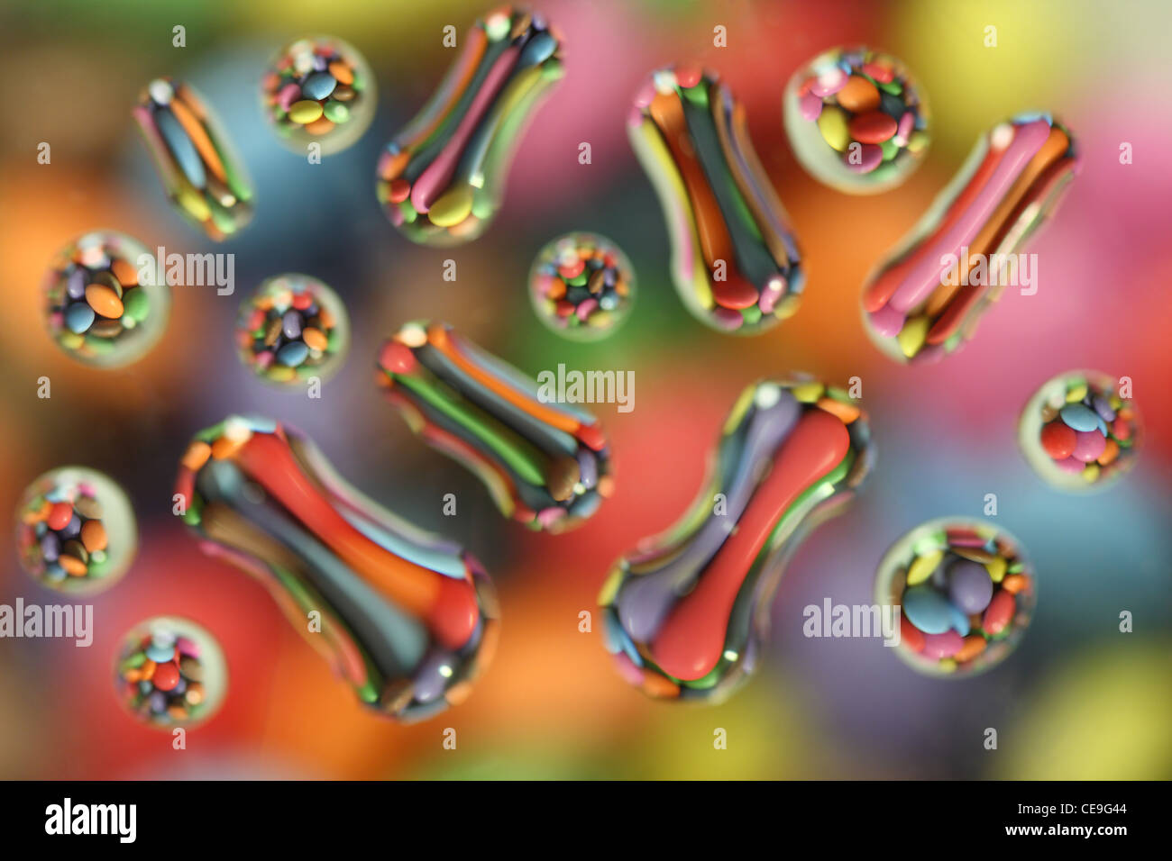 Coloured sweets through water droplets Stock Photo - Alamy