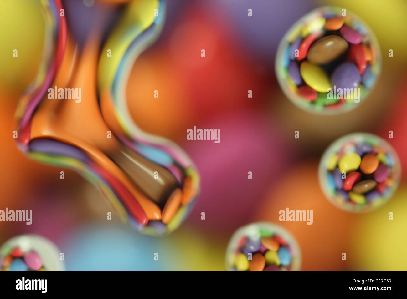 Coloured sweets through water droplets Stock Photo - Alamy