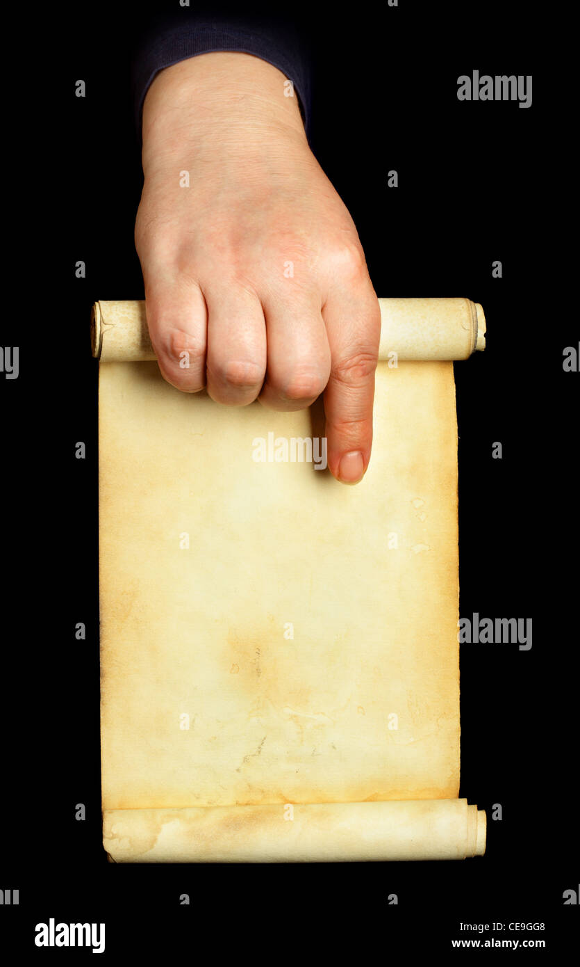 Hand holding old manuscript over black background Stock Photo - Alamy