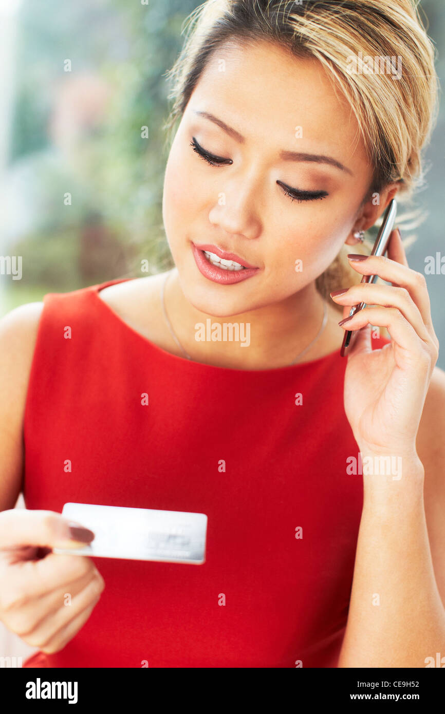 Woman paying by credit card over the phone Stock Photo - Alamy