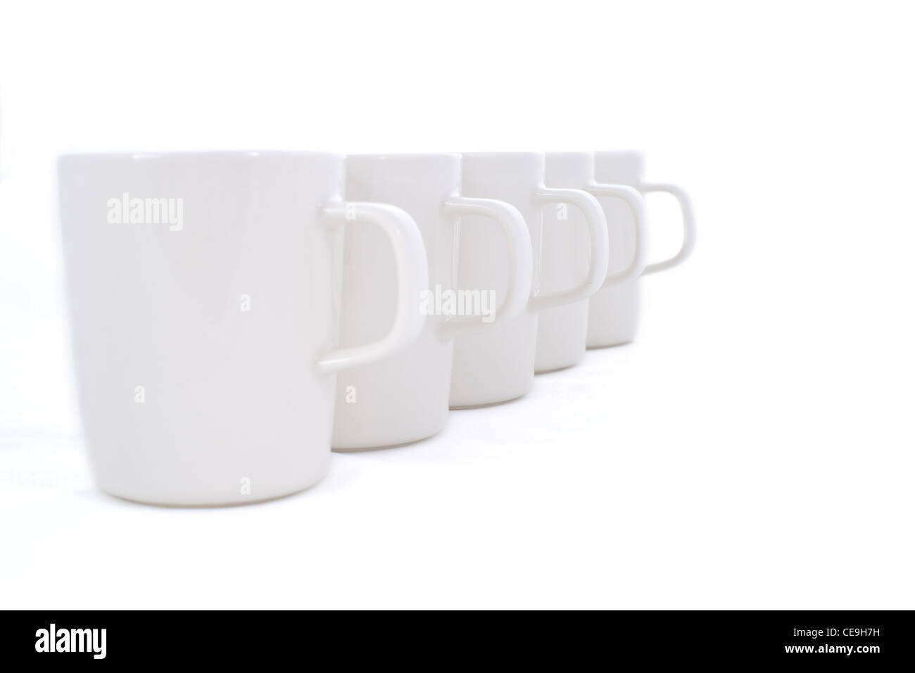 Line of white cups, on white background Stock Photo - Alamy