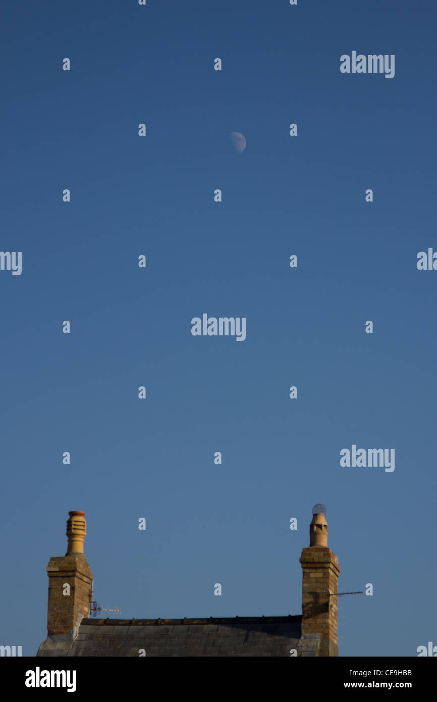 Chimney pots and moon on a clear blue sky Stock Photo - Alamy
