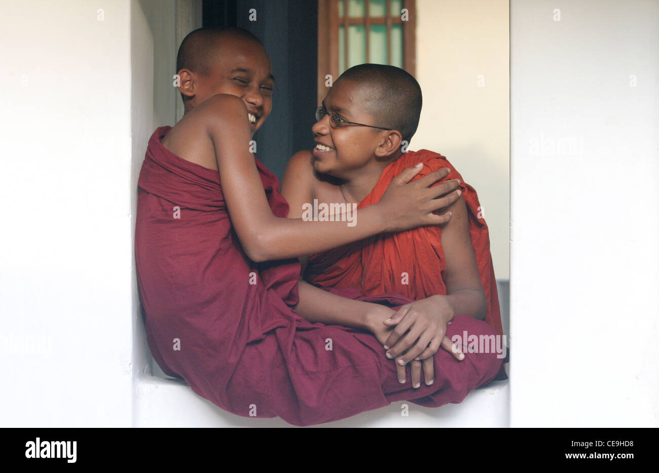 Two young Buddhist monks laugh together Stock Photo - Alamy