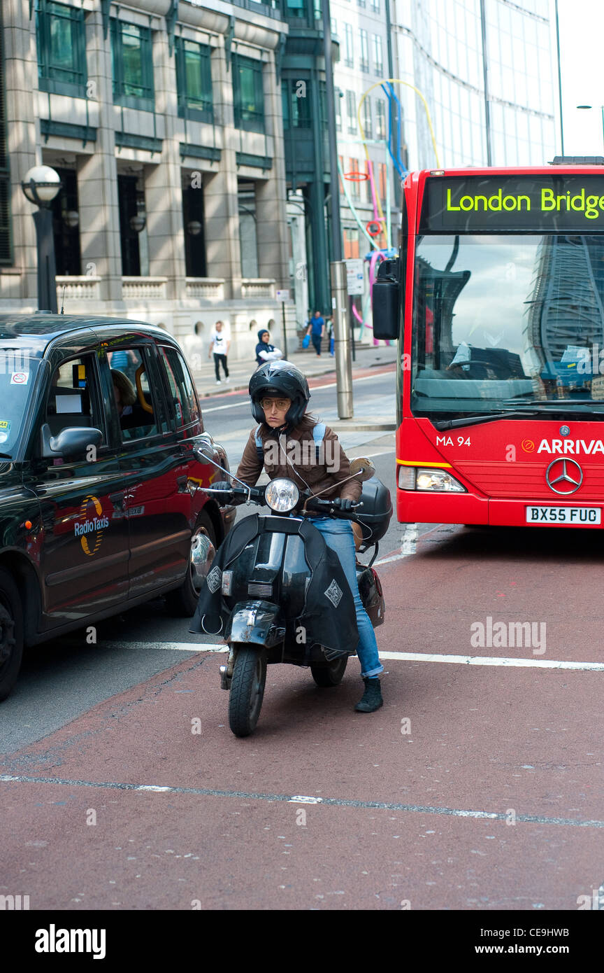 Female motorcycle rider waiting in traffic in the centre of the City of ...