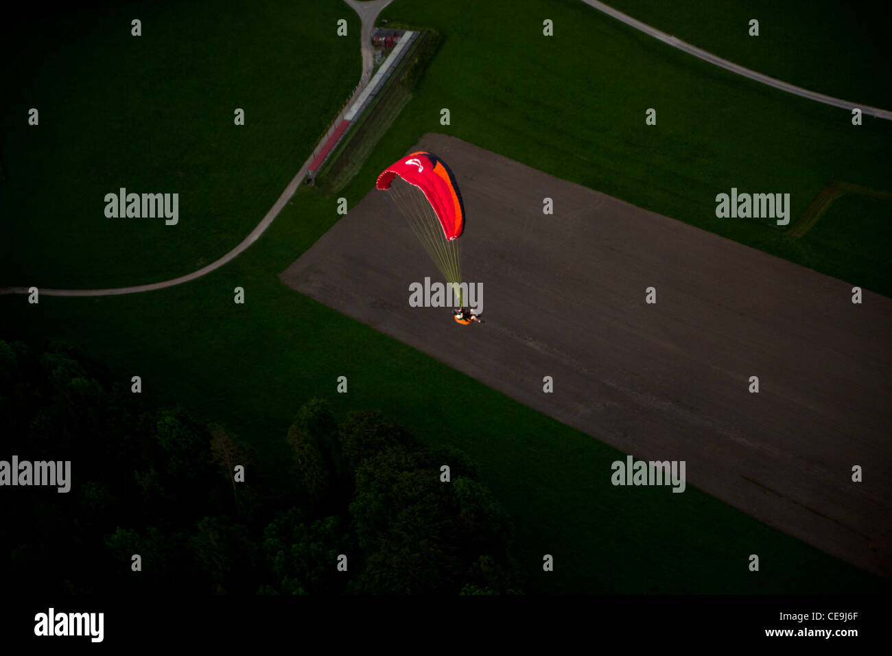 Acro paraglider pilot performing tricks over Interlaken, Switzerland ...