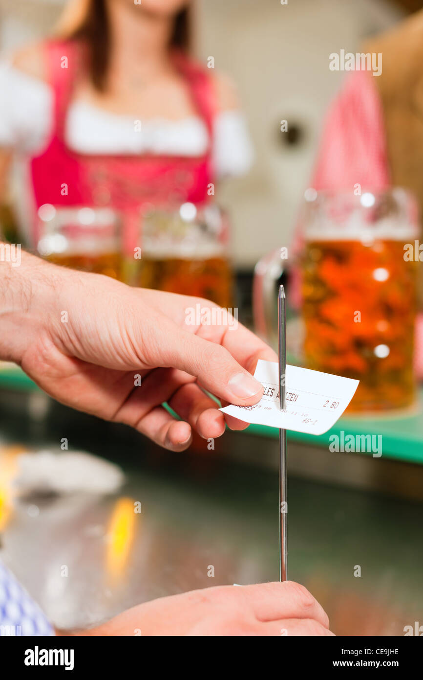 Waiter – only hands to be seen - in a Bavarian pub taking orders Stock ...