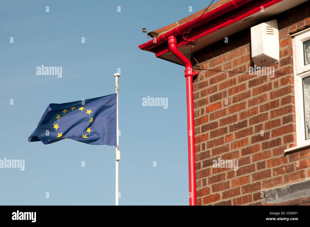 European Union flag flying from a flagpole in a typical English Suburb ...