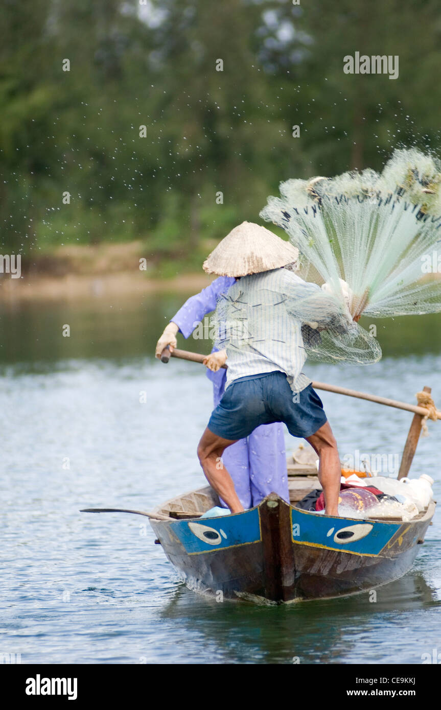 A fisherman swings his large weighted net round his head and into the ... A fisherman swings his large weighted net round his head and into the ...