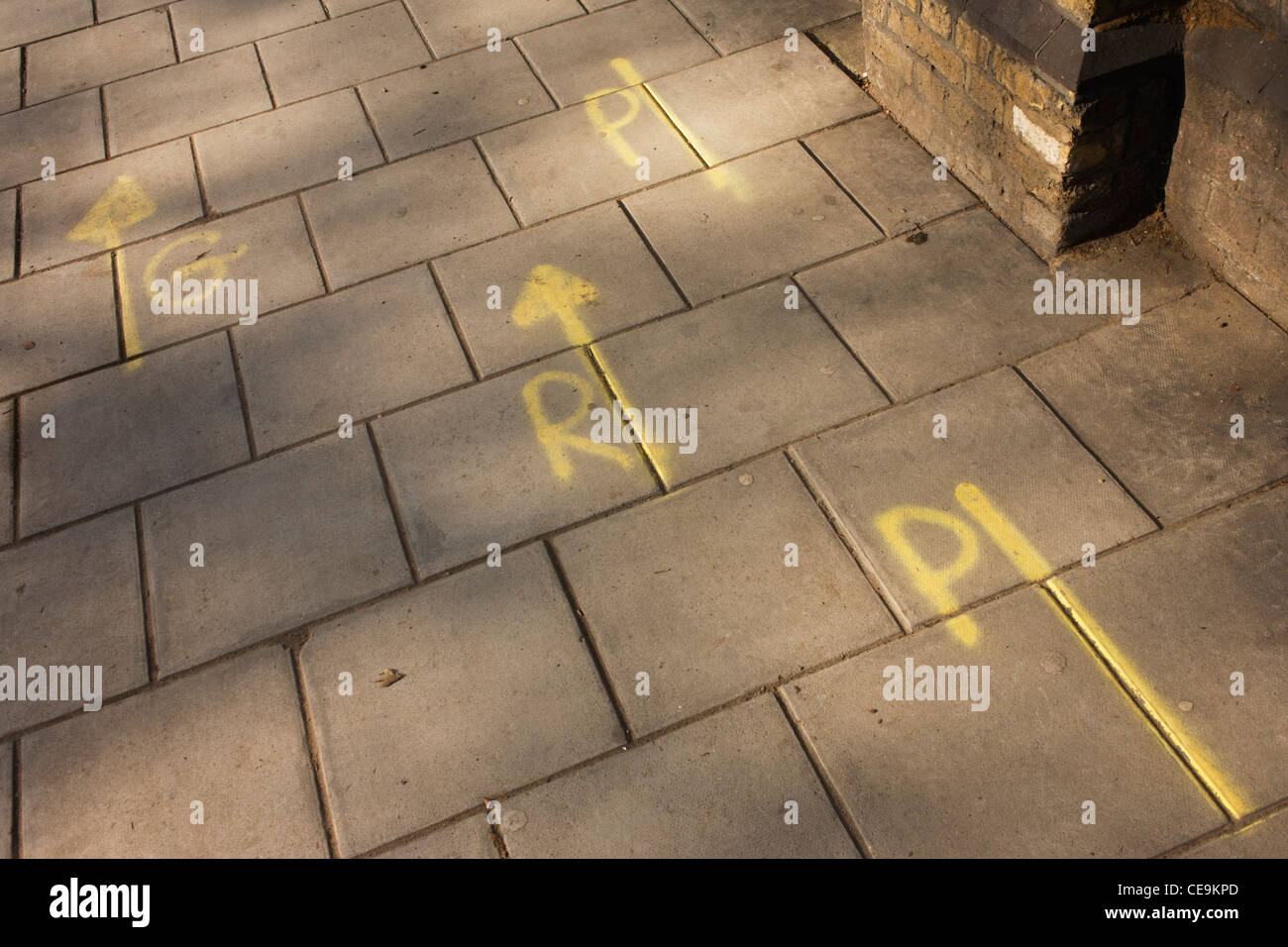 Oddly coloured letters sprayed on to a city pavement (sidewalk ...