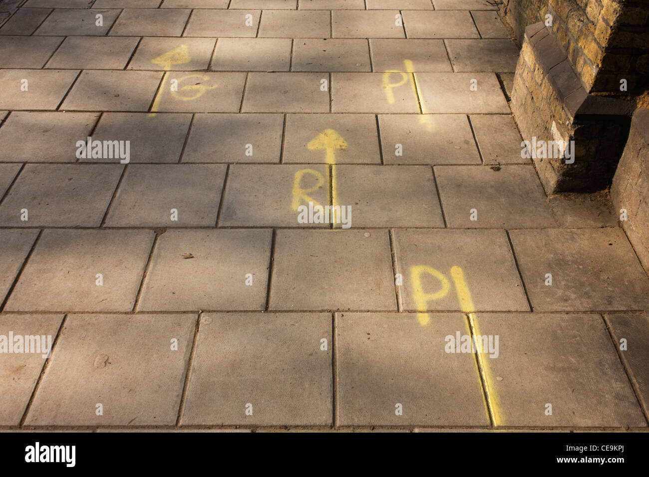 Oddly coloured letters sprayed on to a city pavement (sidewalk ...
