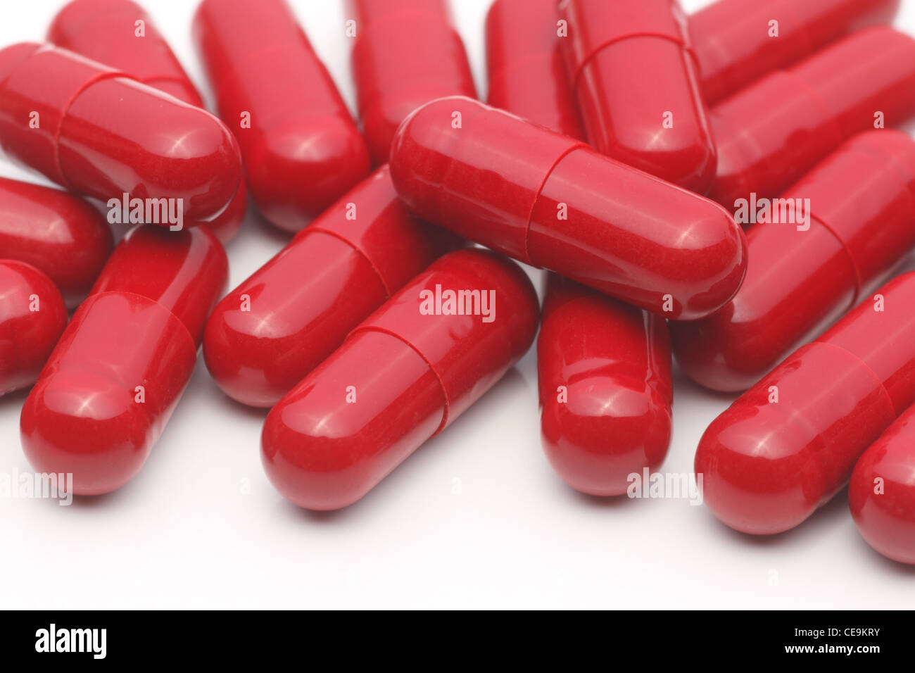 A group of red medicinal capsules on white Stock Photo - Alamy