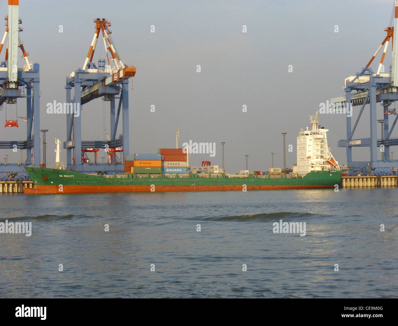 The DS Agility, a feeder ship, is docked at the container terminal. It ...