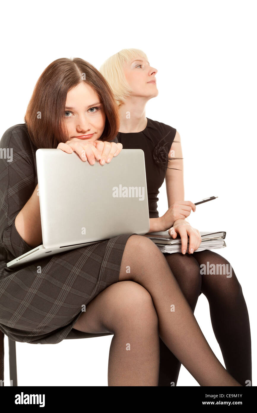 Two beautiful women sitting on the chair Stock Photo - Alamy
