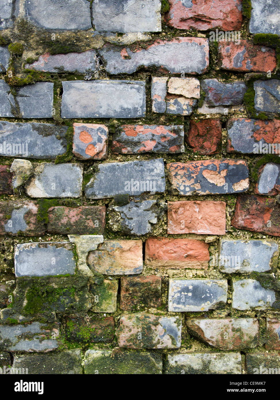 Crumbling bricks and mortar in a very old brick wall that is in poor ...