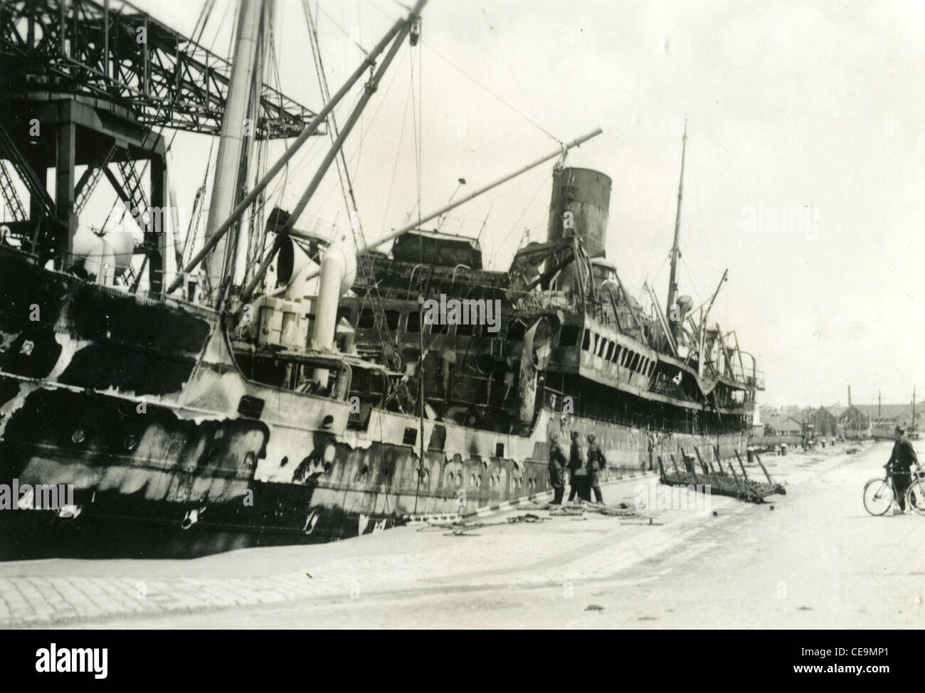 destroyed ship with Nazi German soldiers standing next during WWII ...