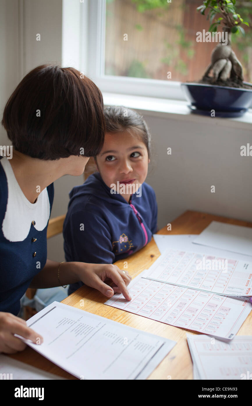 Tutor teaching private lessons to a young child Stock Photo - Alamy