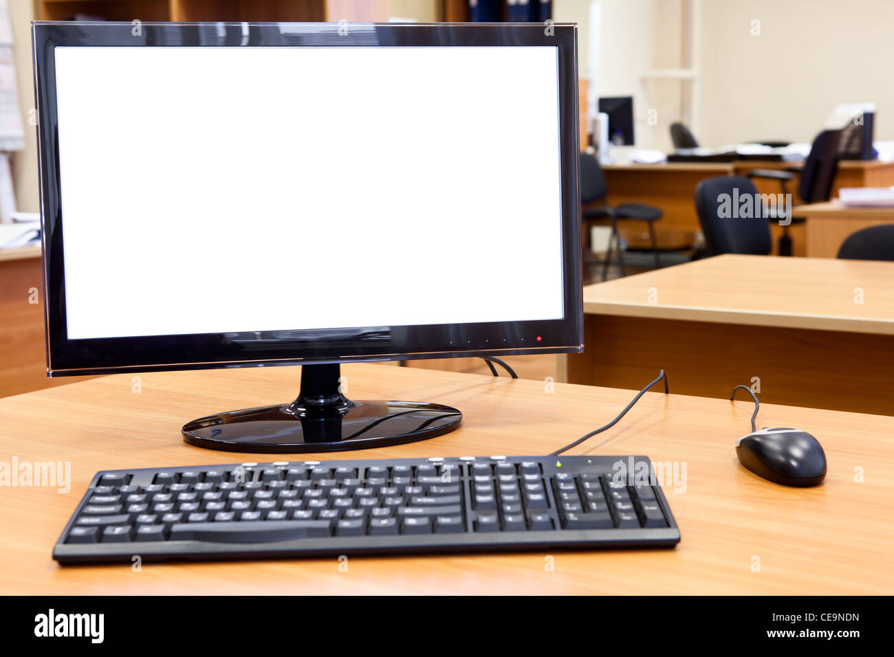 Modern personal black color computer on empty desktop in office room ...