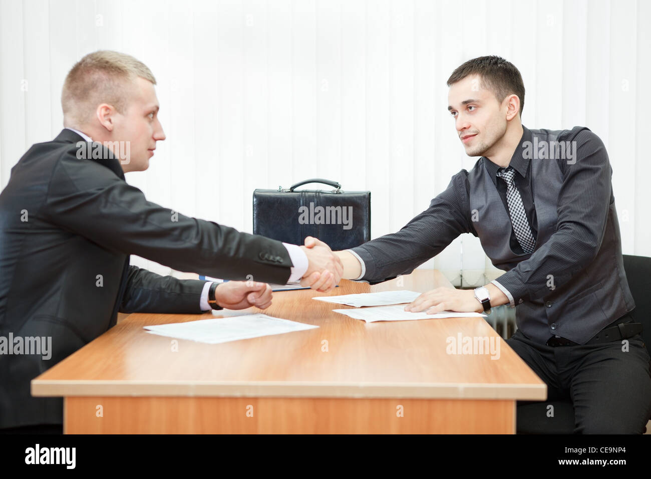 Two men sitting across the desk hi-res stock photography and images - Alamy