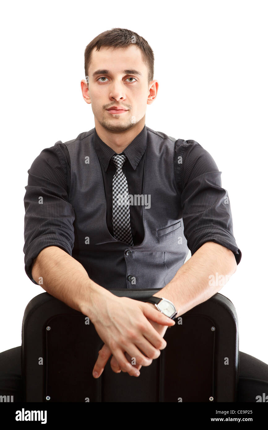 Portrait of young Caucasian smart business man sitting on chair ...